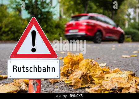 Caution slide sign Stock Photo - Alamy