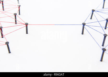 Connecting networks concept - two network connected with yarn red and ...