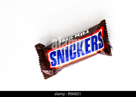 Snickers chocolate bar on white background with open cut up bar by the ...