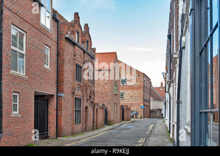 York, England - April 2018: Old brick buildings housing shops and ...