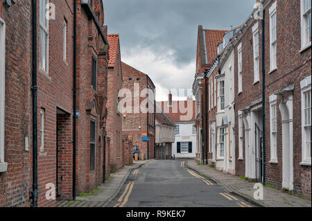 York, England - April 2018: Old brick buildings housing shops and ...