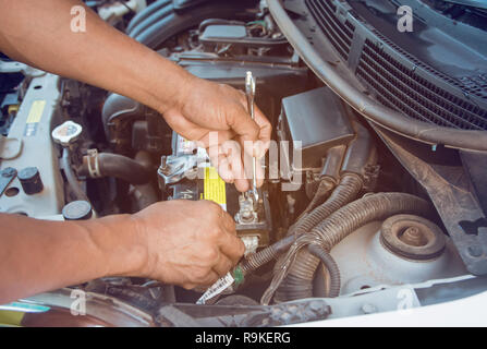 Car mechanic working Install battery with wrench in garage. Repair ...
