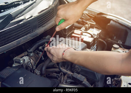 Car mechanic working with screwdriver in garage. Repair service Stock ...
