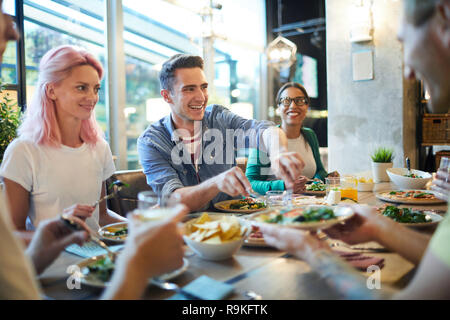 Girl sharing lunch with her friend Stock Photo - Alamy