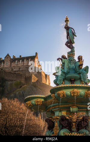Ross fountain lit by golden sunset light at the foot of the Castle Rock ...