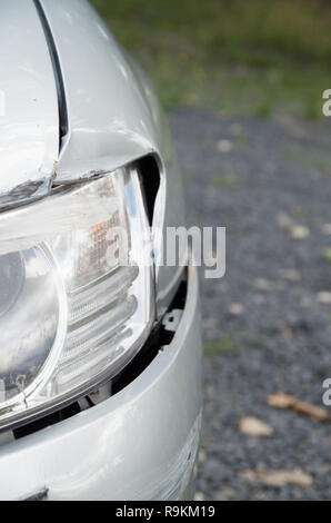 Damaged car headlight and panels after a collision in wet weather Stock ...
