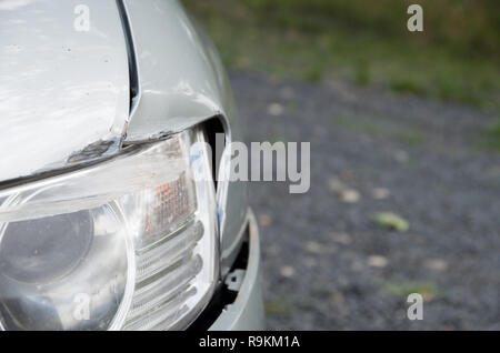 Damaged car headlight and panels after a collision in wet weather Stock ...