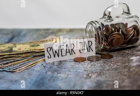 Swear Jar challenge concept with glass jar filled with coins, New Year ...