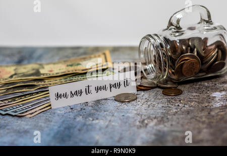 Swear Jar challenge concept with glass jar filled with coins, New Year ...