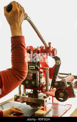 worker operating metal press machine at workshop. Bending of metal on ...