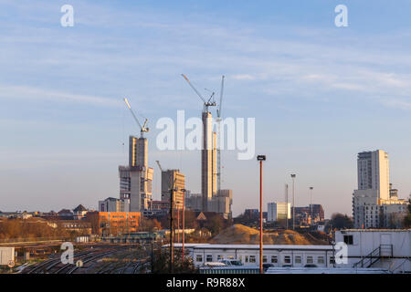 Changing skyline of Woking, Surrey: railway tracks lead to tower cranes ...