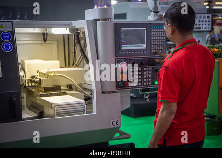 Industrial worker input data programing for CNC milling machine Stock Photo - Alamy