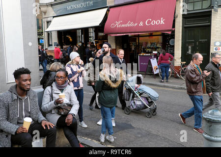 London street scene people drinking coffee at coffee shop Tomtom cafe ...