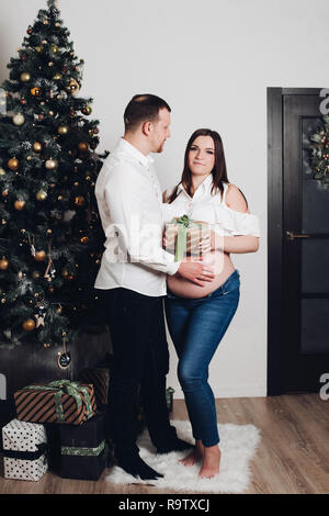 Cheerful man with gift boxes on winter time outdoors Stock Photo - Alamy