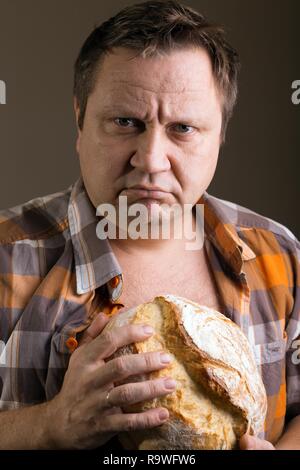 a man and a loaf of bread. human emotions Stock Photo - Alamy