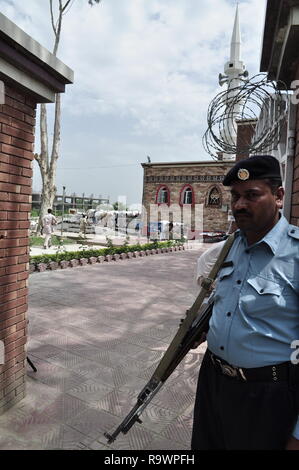 A policeman guards red mosque, also know as laal masjid in Islamabad ...