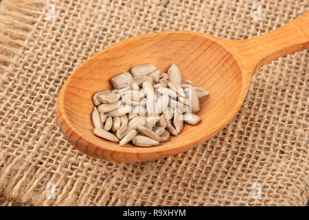 Sunflower seeds without shell in a wooden scoop on a white background ...