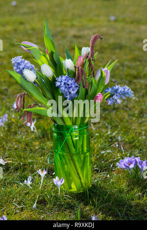 Colorful spring flowers in a glass Stock Photo - Alamy