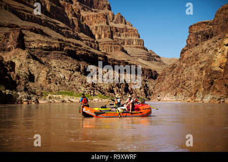 A middle aged man raft a floating picnic table on a lake. Texas, USA ...