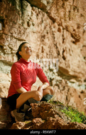 Vertical photo of young woman hiker enjoying the autumn sun up in the ...
