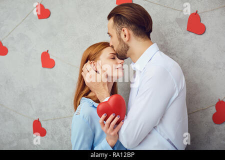 happy couple with red heart on valentines day Stock Photo - Alamy