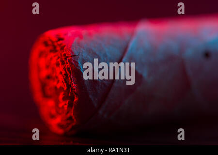 Close up of cigars in neon light Stock Photo - Alamy