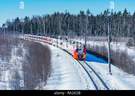 Modern high-speed train approaches to the station at autumn morning ...