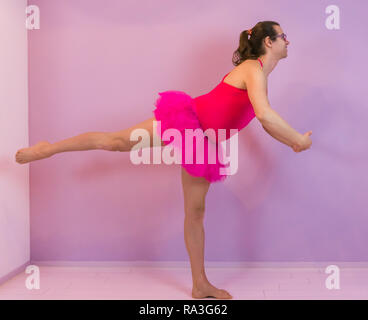 funny young transgender girl performing a developpe, classical ballet ...