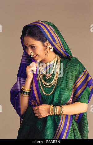 A PORTRAIT OF A MARATHI/MAHARASHTRIAN Bride dressed in traditional ...