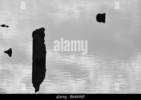 Shadow of object forming on water during sunset Stock Photo - Alamy