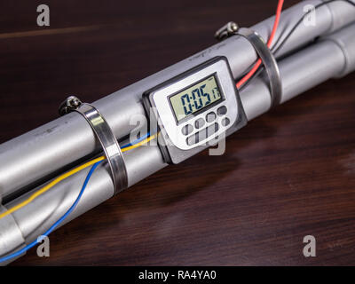 Pipe bomb with an lcd clock timer to trigger detonation, on wooden ...