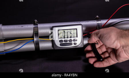 Hand cutting wire on pipe bomb with an lcd clock timer to trigger ...