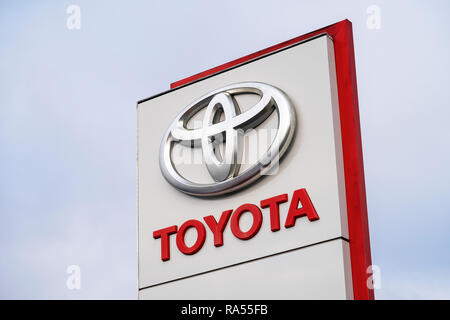 Sign with logo for Toyota, low-angle view against overcast sky, Oakland ...