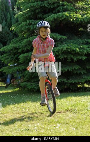 Girl riding a unicycle Stock Photo - Alamy