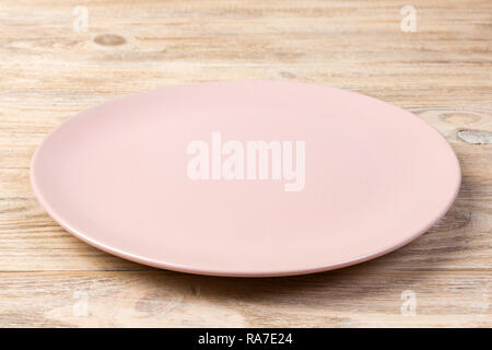 Perspective view of empty pink plate on cement background. Empty space ...