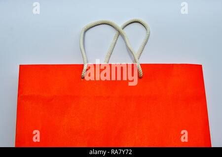 orange paper bag with white nylon handle Stock Photo - Alamy