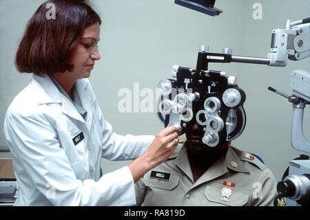 1978 - A female U.S. Army optometrist conducts an eye exam Stock Photo ...