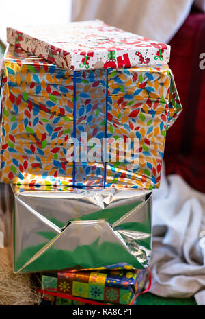 Stacked gift boxes wrapped in grey silver paper with polka dots pattern ...