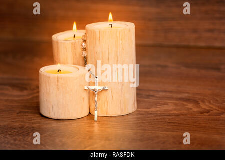 Silver rosary with Jesus on the Candle at wooden table,religion concept ...