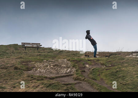 A man leaning into a strong wind Stock Photo - Alamy