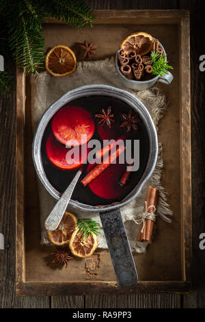 Aromatic and homemade mulled red wine on rustic table Stock Photo - Alamy