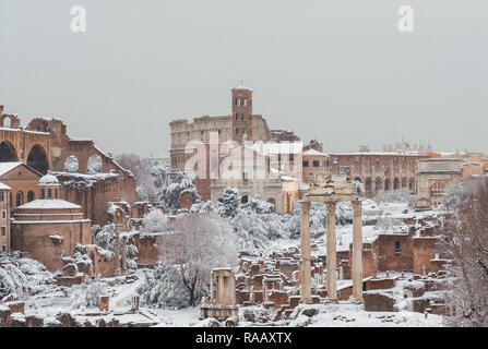 Frozen Rome. View of Roman Forum ancient ruins and Coliseum covered by ...