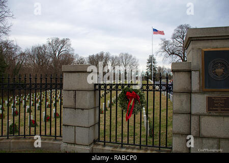 Entrance gate to Annapolis National Cemetery with grave stones in ...