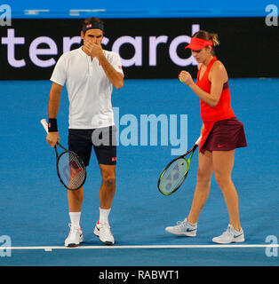 Belinda Bencic with Roger Federer of Switzerland during the mixed ...