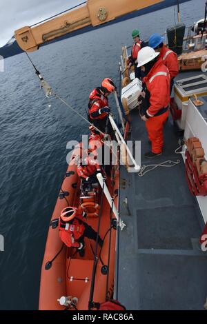 US Navy Crewmembers aboard a patrol craft assigned to Coast Guard Port ...