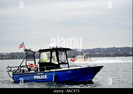 US Navy Crewmembers aboard a patrol craft assigned to Coast Guard Port ...