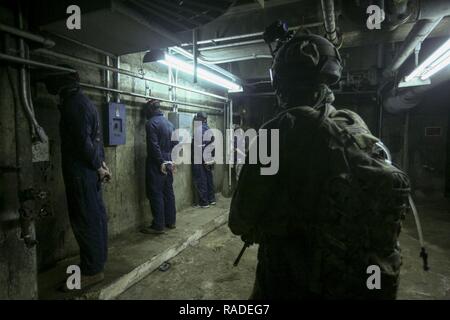 A Marine sniper provides security from the back of an Oshkosh M-ATV ...