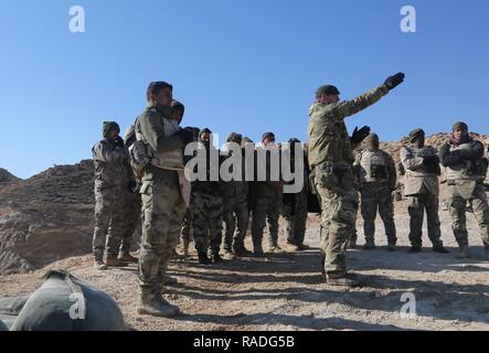 A British trainer from 4th Battalion "The Rifles" indicates a target ...