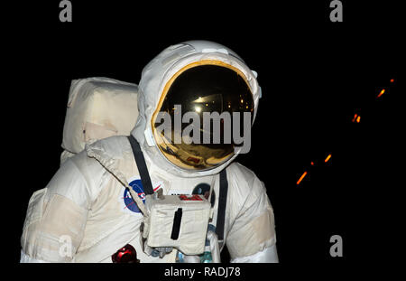 Astronaut in spacesuit close up isolated on black background. Planet ...