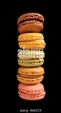 macaroons of different colors on a black background Stock Photo - Alamy